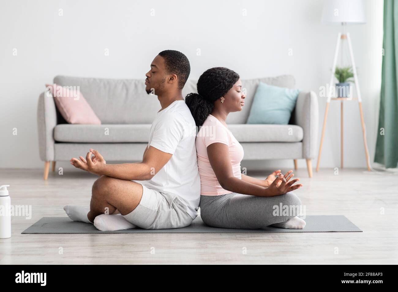 Sporty young couple meditating hi-res stock photography and images - Alamy
