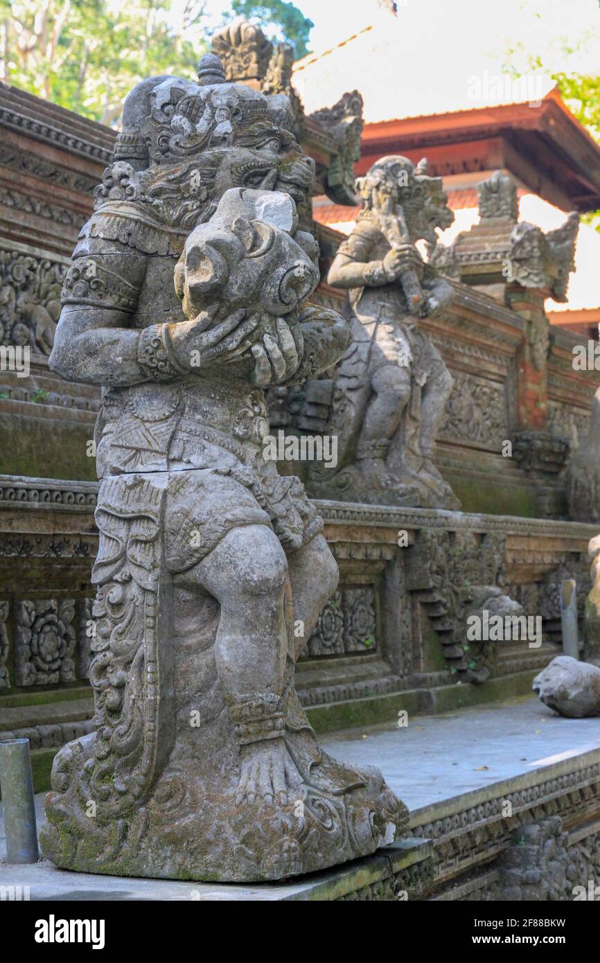 Traditional carved stone statues at Monkey Temple in Ubud, Bali ...