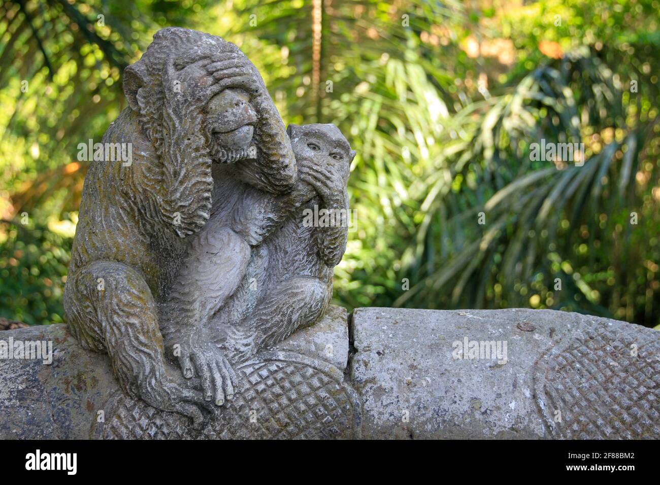 Carved stone monkey with baby statue at Monkey Temple in Ubud, Bali ...