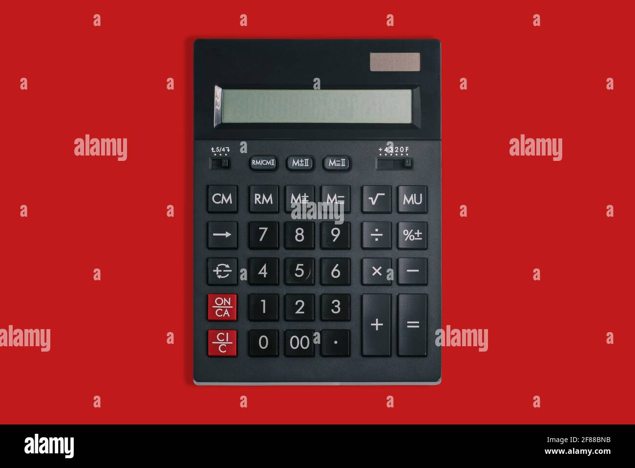 Calculator isolated on a red background. Black calculator with buttons ...