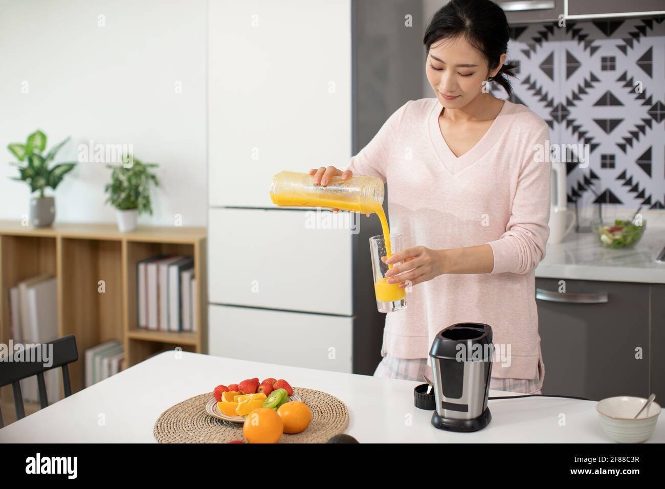 Woman pouring strawberry juice hi-res stock photography and images - Alamy