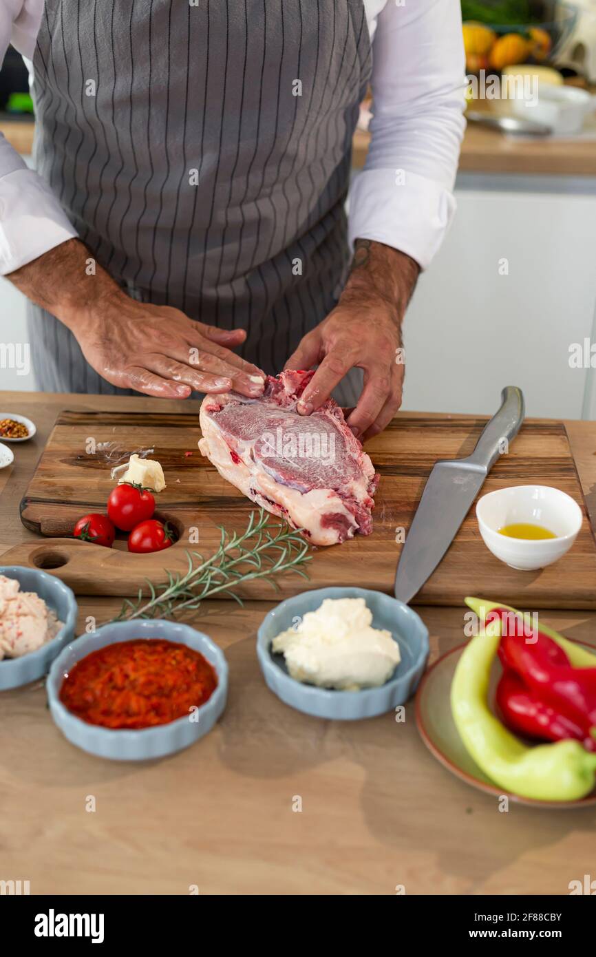 A close-up of the chef's hands in the preparation phase with which he ...