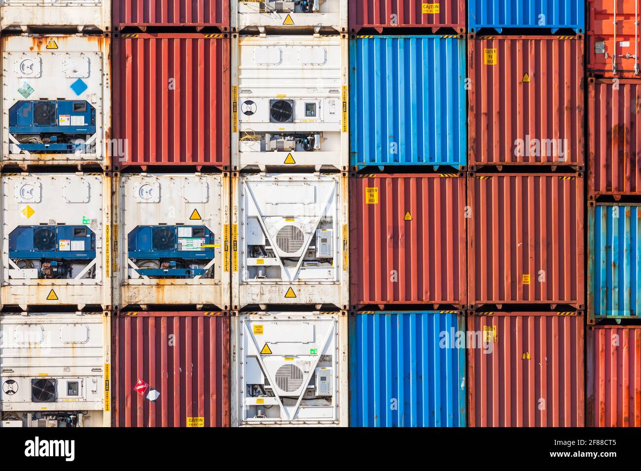 Stacked freight shipping containers and refrigerators photo background ...