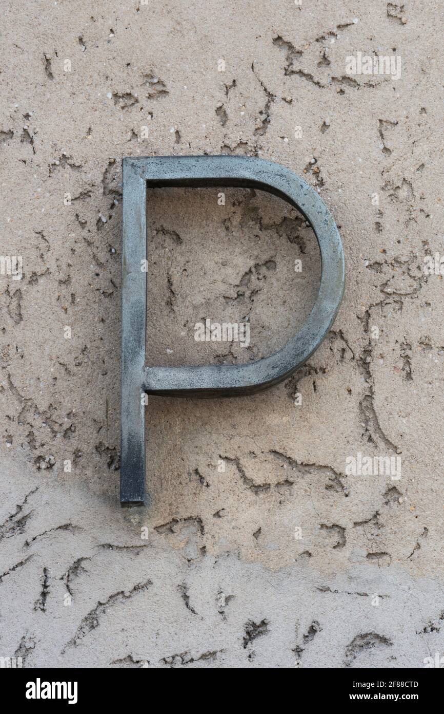 Metal letter P on a house facade Stock Photo - Alamy