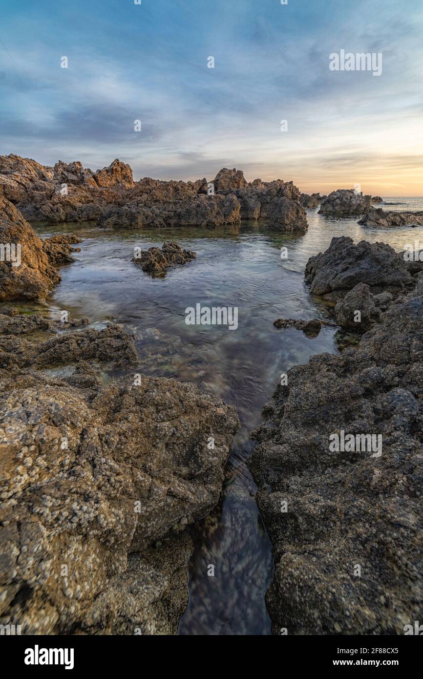 Small inlet of sea water at sunrise. Colors of the mediterranean ...
