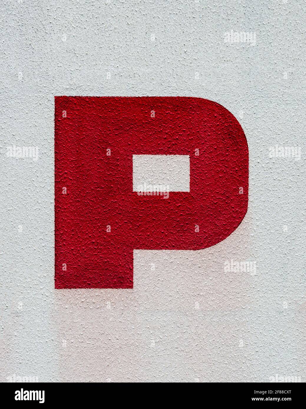 Bold red letter P painted on a white wall Stock Photo - Alamy