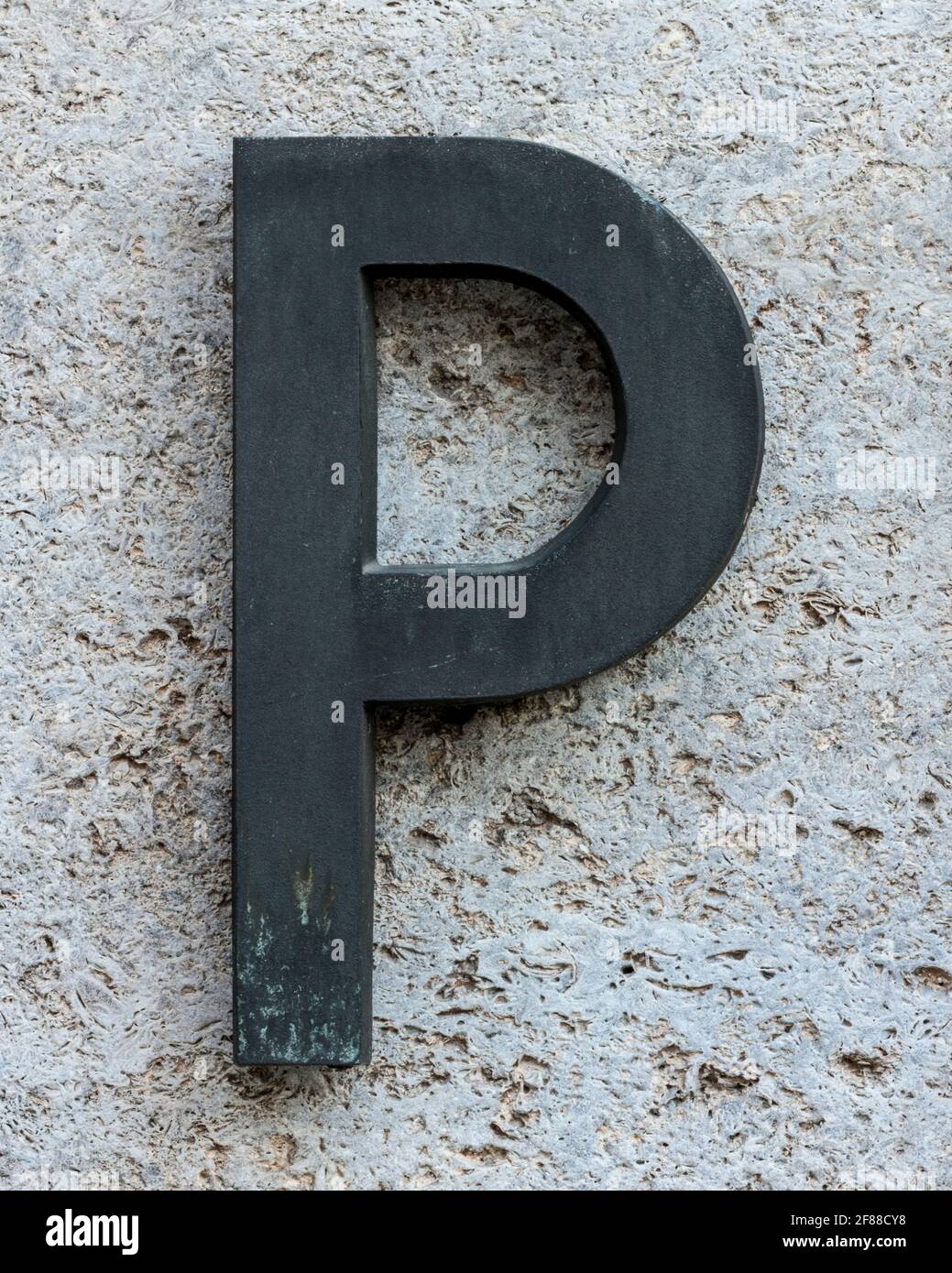 Metal letter P on a stone wall Stock Photo - Alamy