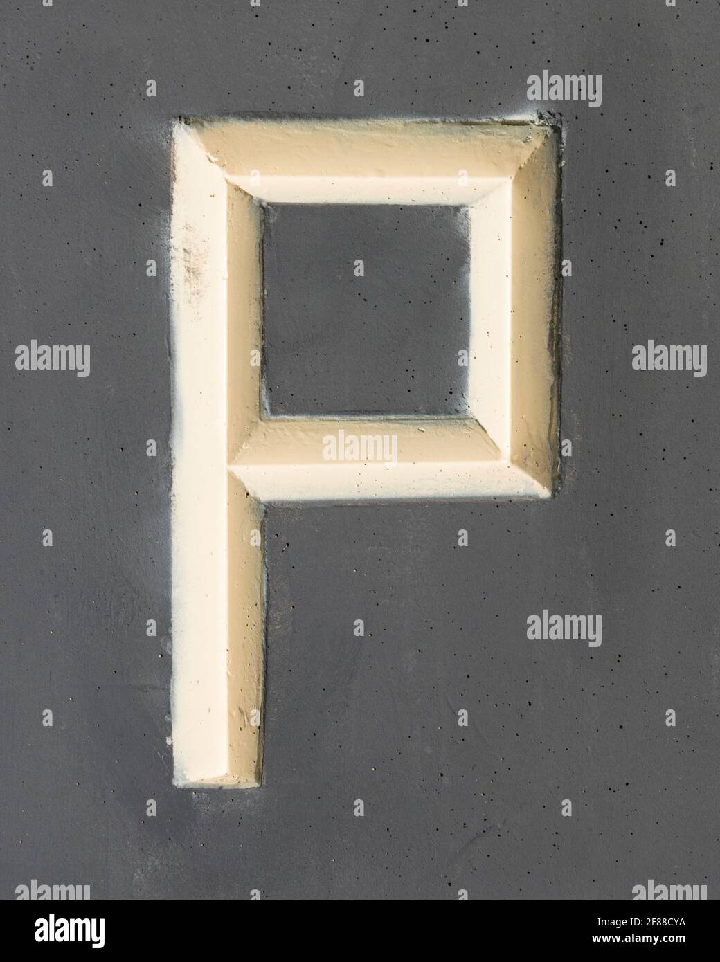 Beige letter P inverse relief in grey painted concrete Stock Photo - Alamy