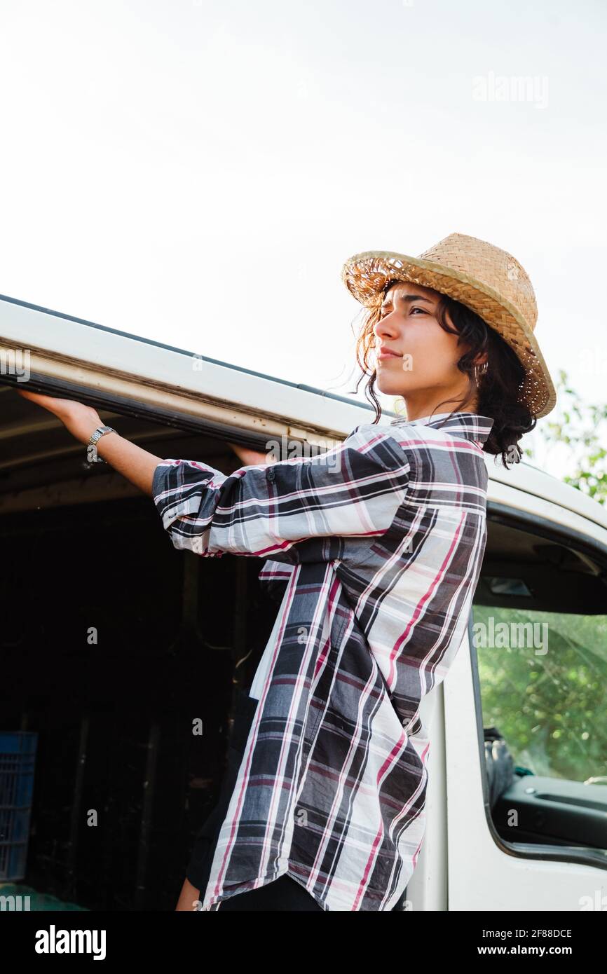 Young farmer woman in a van looking out at crop field Stock Photo - Alamy