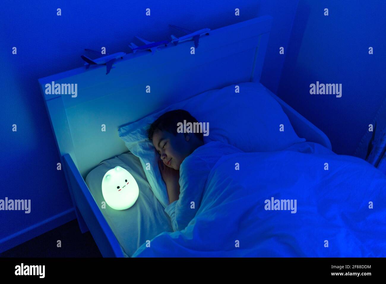 boy sleeping with led night lamp, soft focus Stock Photo - Alamy