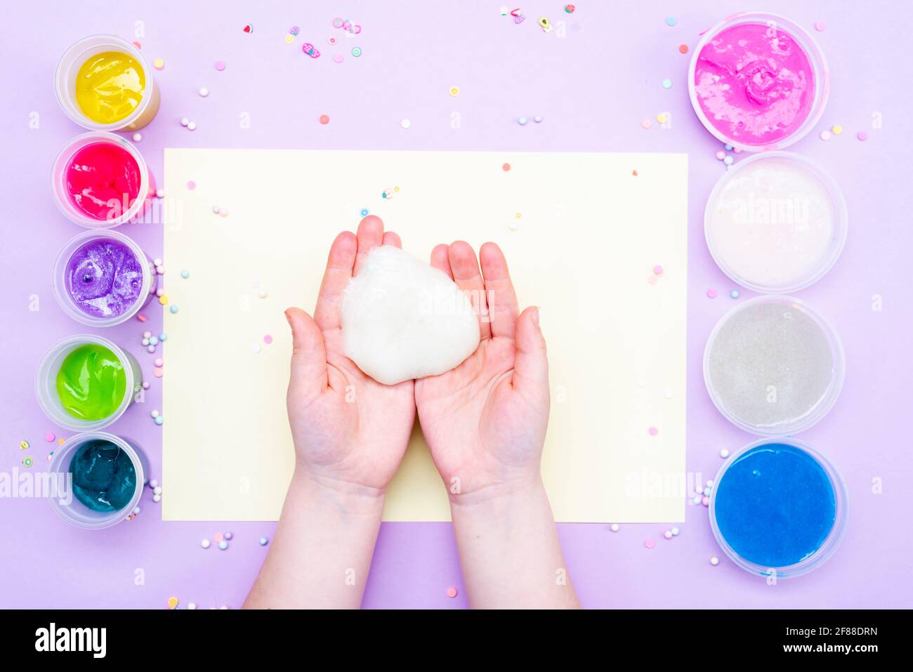 Multi-colored slimes on the table. The child plays with slimes. Play ...