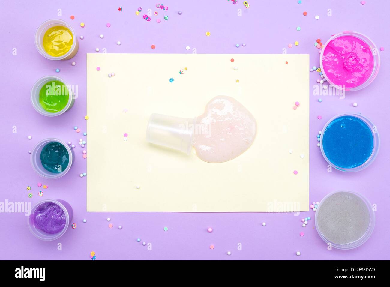 Multi-colored slimes on the table. The child plays with slimes. Play ...