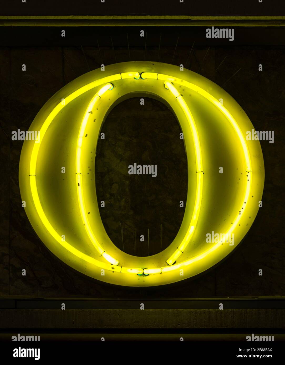 Shining yellow neon letter O Stock Photo - Alamy