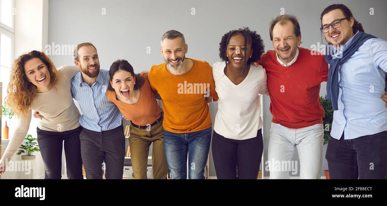 Banner with team of happy diverse people huddling, laughing and having ...