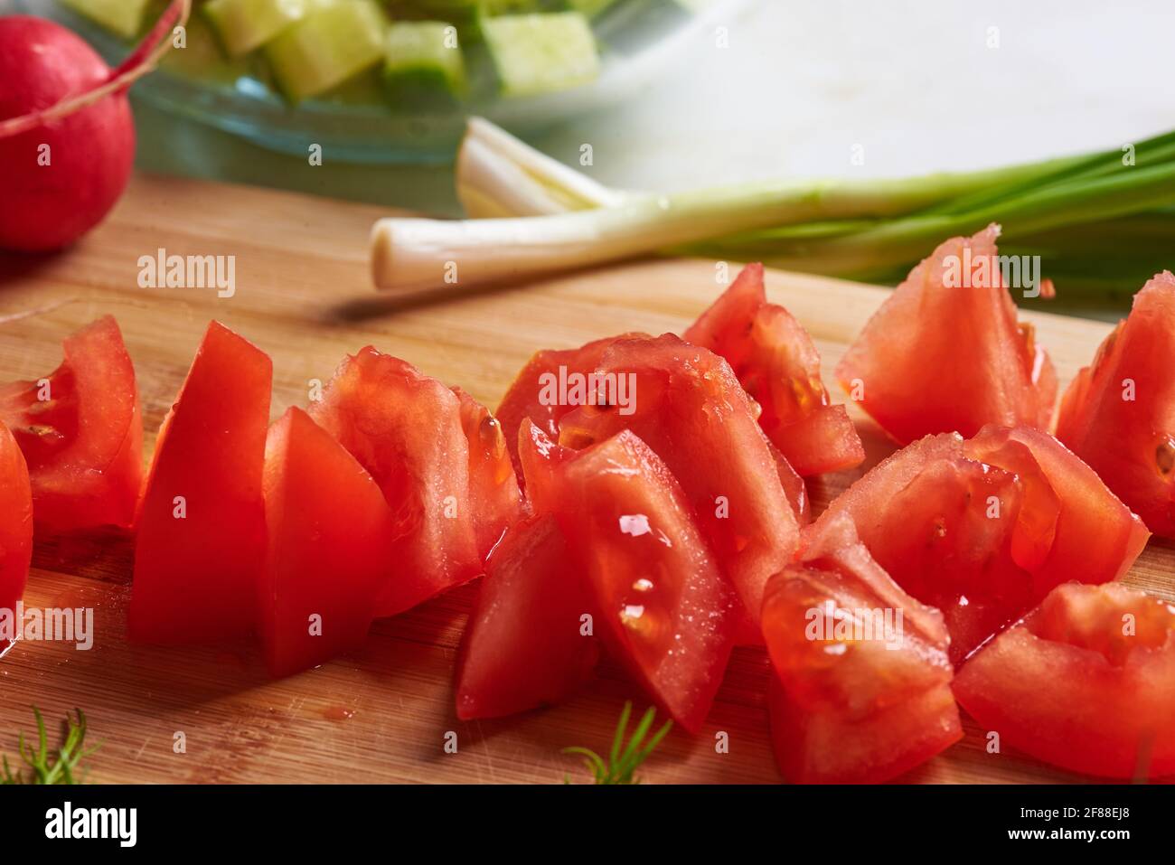 there is a red tomato sliced on the board Stock Photo - Alamy