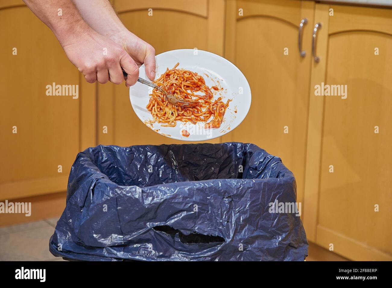 Throwing out wasteful excess food Stock Photo - Alamy