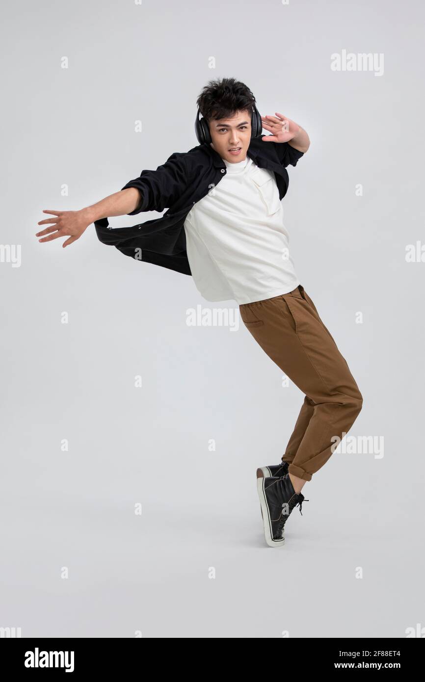 Cool young man dancing with headphones Stock Photo - Alamy