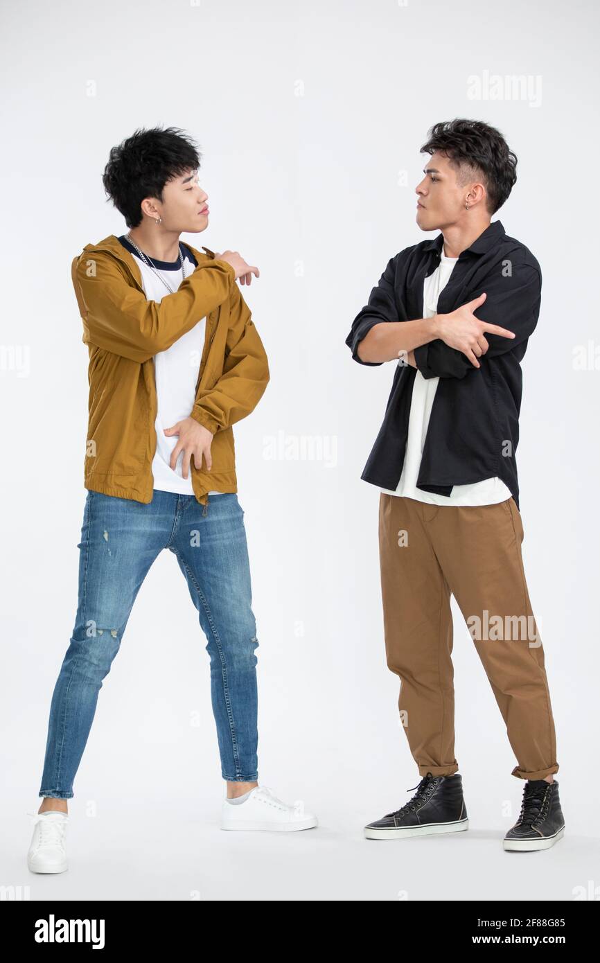 Young men standing face to face Stock Photo - Alamy