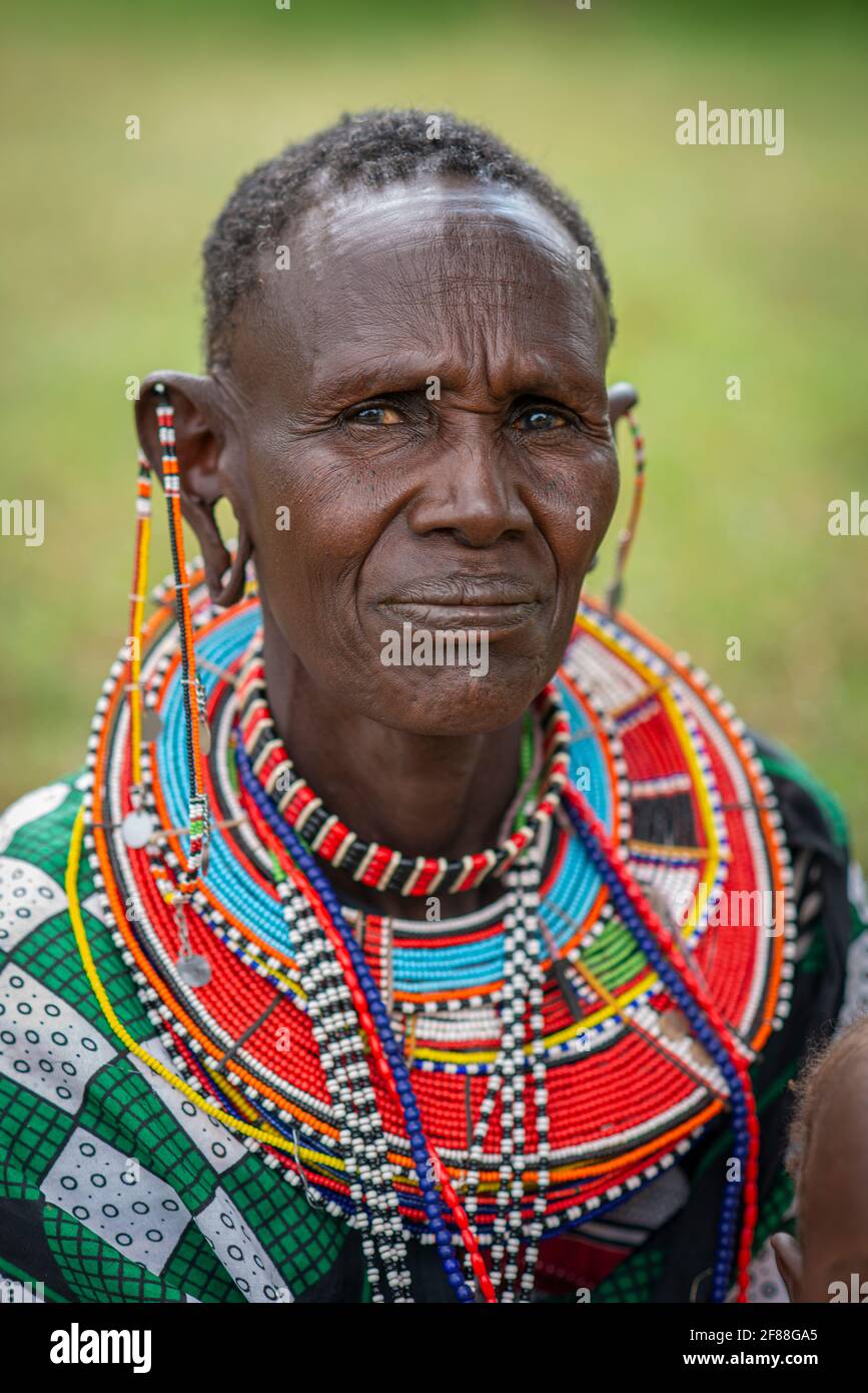 traditional Maasai woman wearing beaded necklace and colorful shuka ...