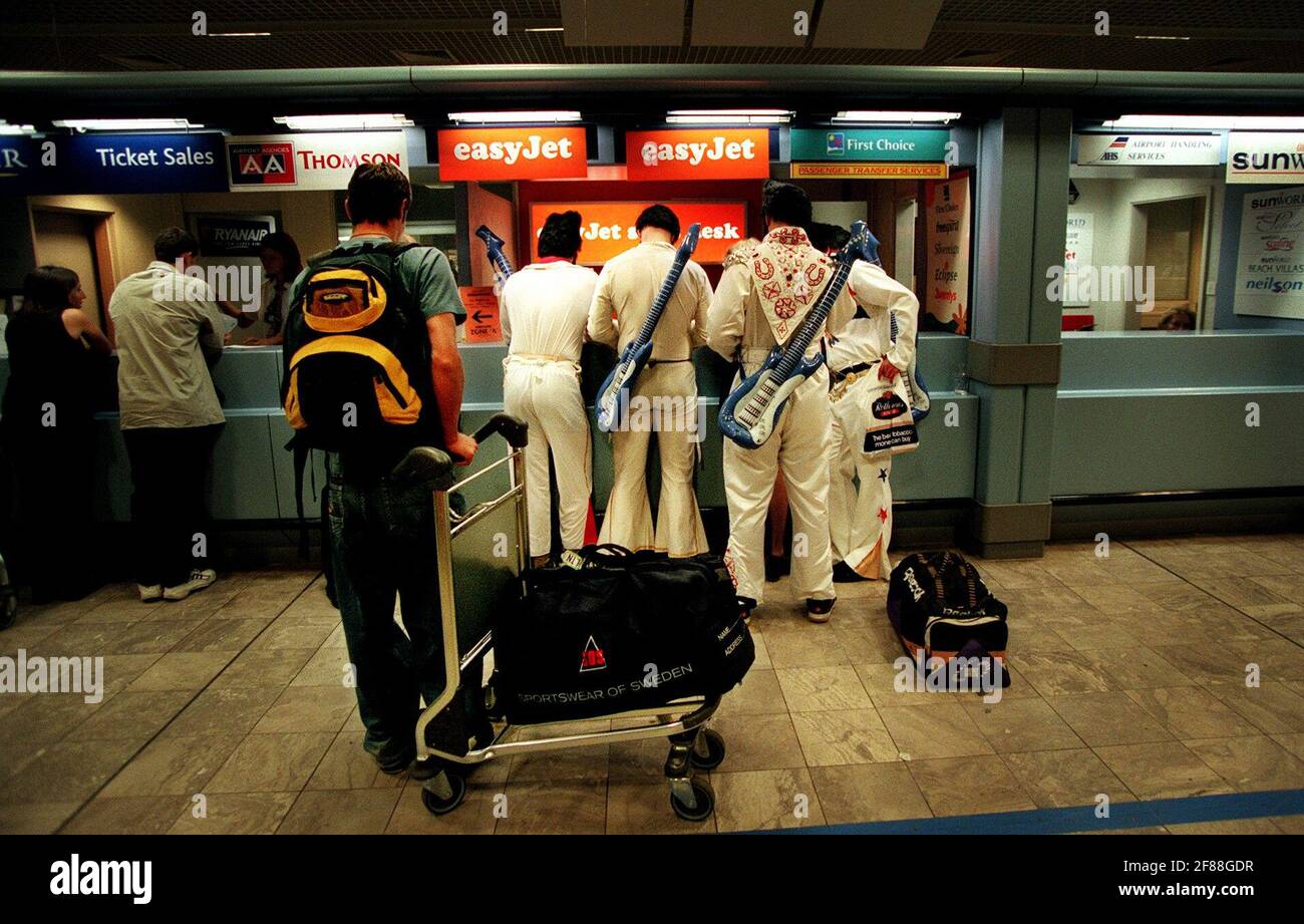 Elvis Lookalikes buying tickets at luton airport for the summer break ...