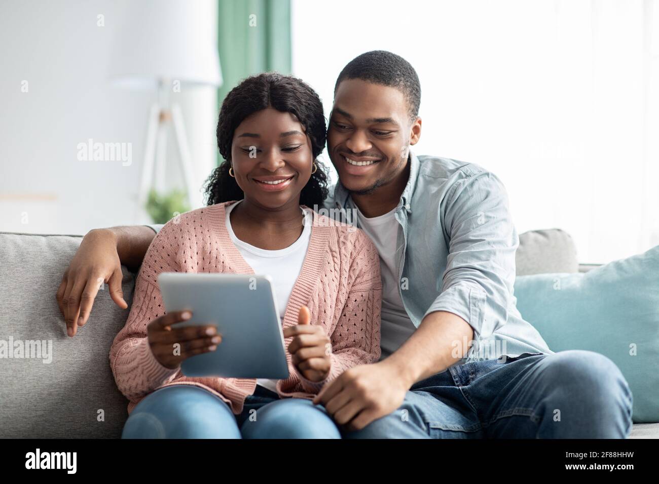 Relaxed african american family using digital tablet together Stock ...