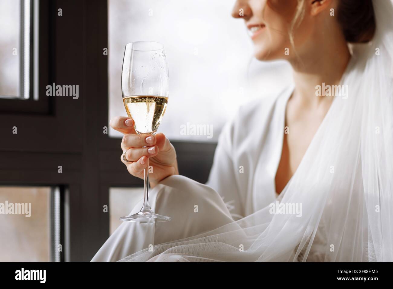 Bride s morning. Bride drinking champagne in the peignoir. young woman ...