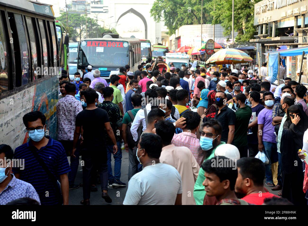 Dhaka, Bangladesh. 12th Apr, 2021. People waits at a bus stop for ...