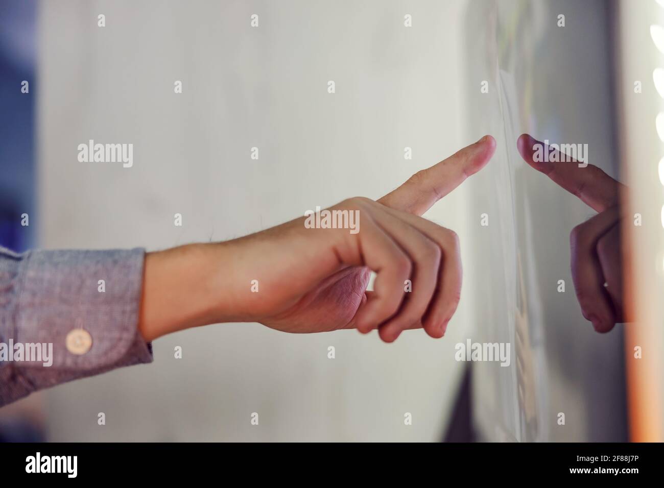 Multimedia 3D touch screen. A male hand touches the computer screen ...