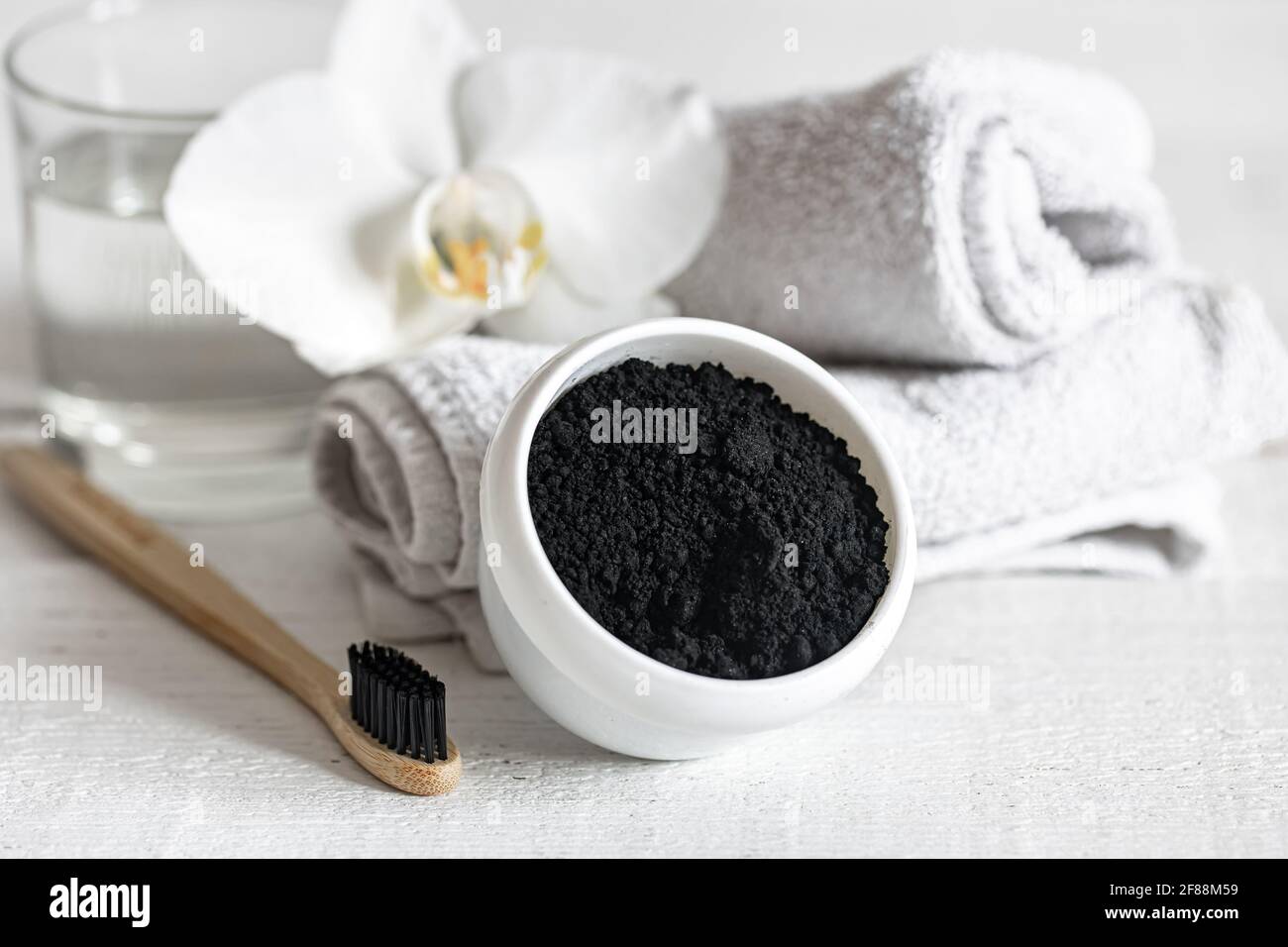 Composition with wooden natural toothbrush and black powder for teeth ...