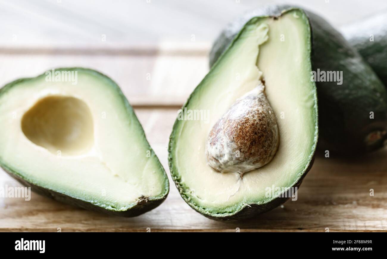 Cutaway of a fresh ripe avocado. Healthy food, diet and raw food diet ...