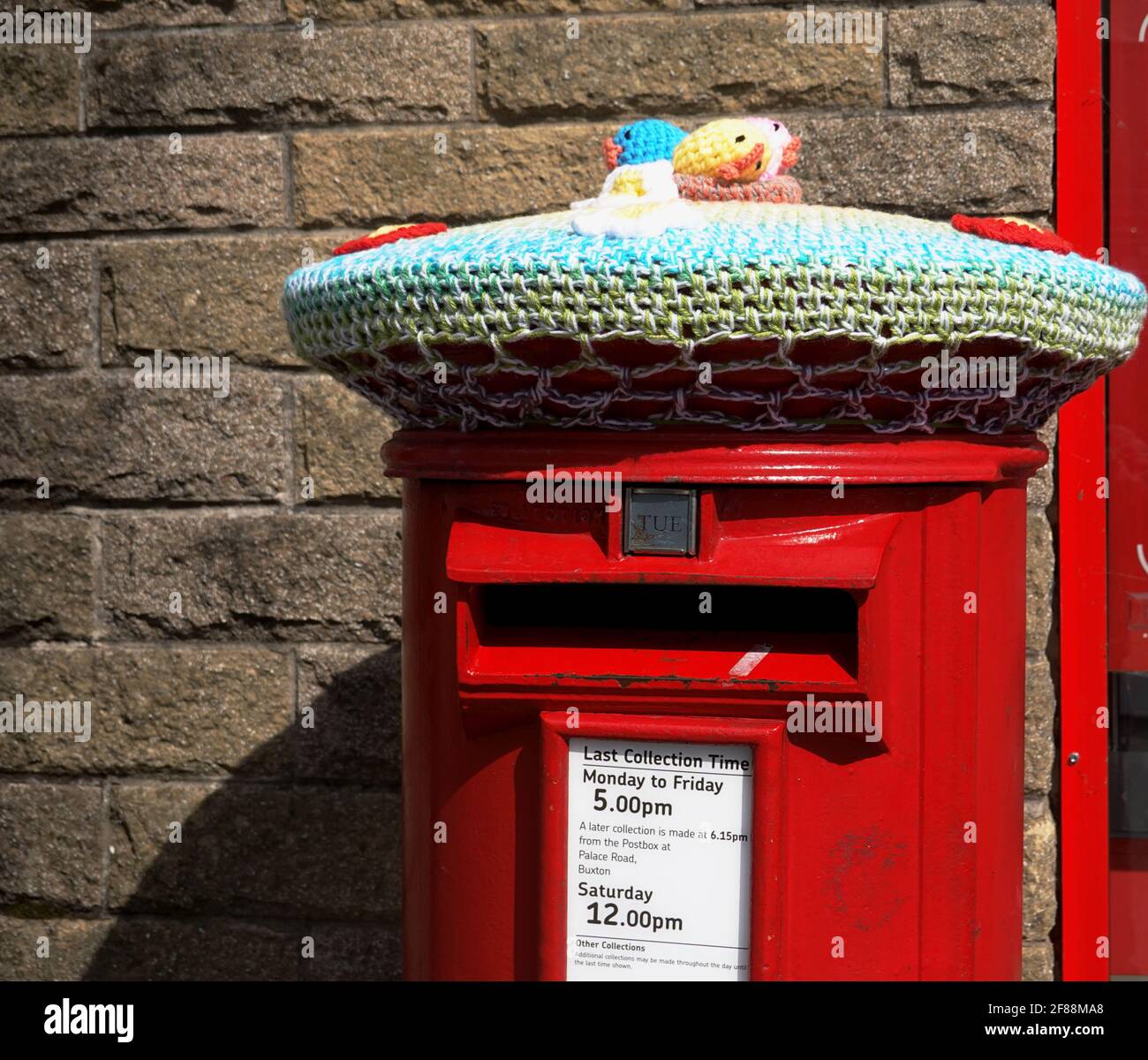 The letter box outside New Mills Post Office has a woolencovering Stock ...
