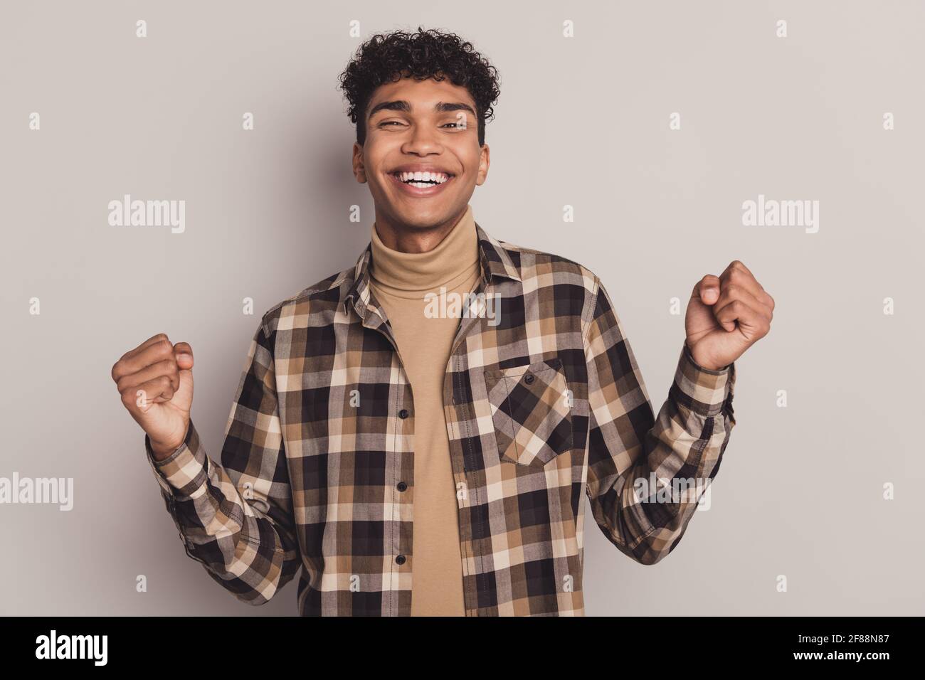 Photo of funny guy raise fists look camera wear checkered shirt ...