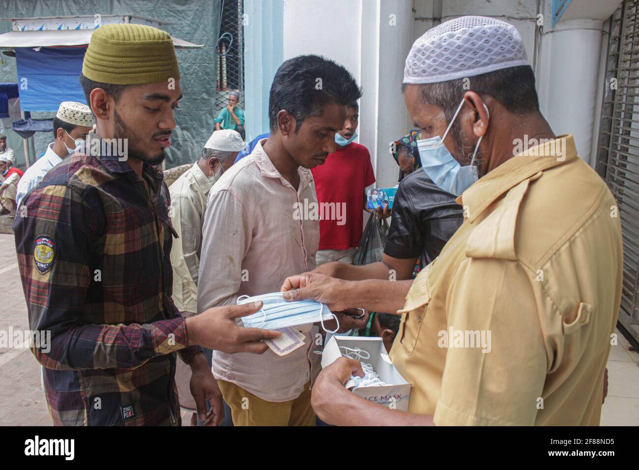 Mosque committee members are providing mask to Muslim Worshipers who ...