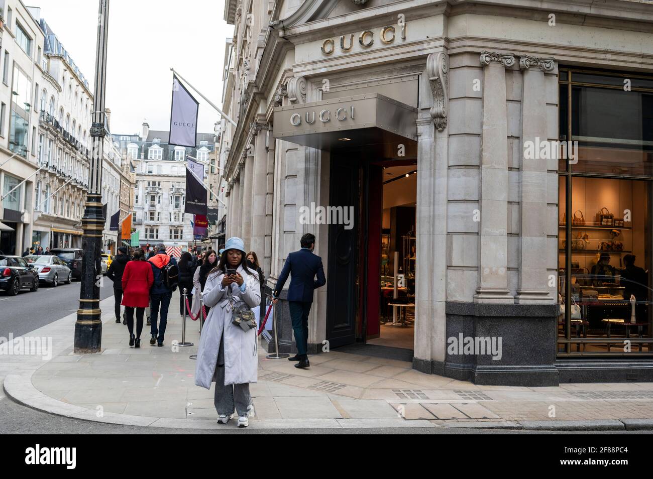 London, UK. 12 April 2021. People queue to enter the Gucci store in Old ...