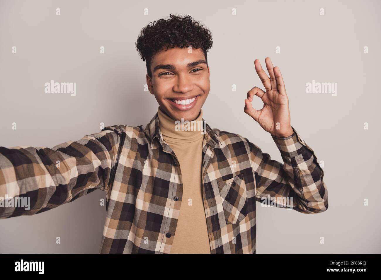 Photo of trendy handsome brunette dark skin man make selfie show okay ...
