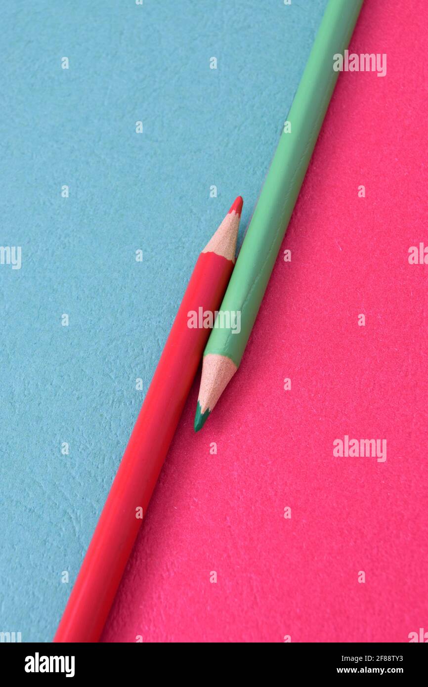 Two colored pencils split a picture in half in two different colors ...