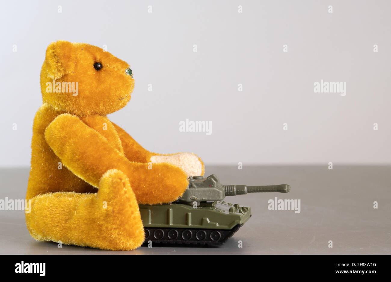 Teddy bear with a toy tank Stock Photo - Alamy