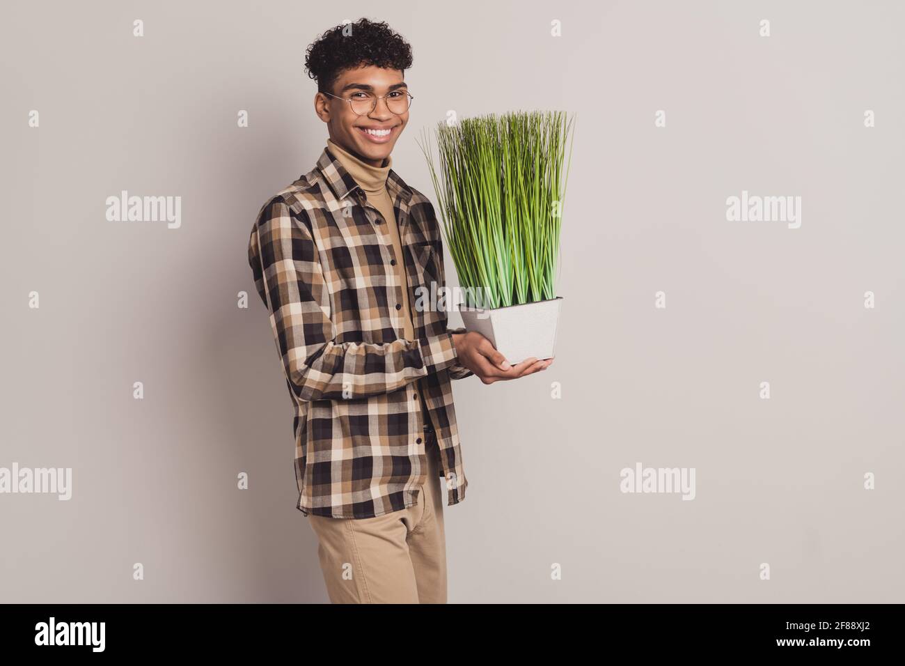 Photo of african guy hold pot plant wear eyeglasses checkered shirt ...