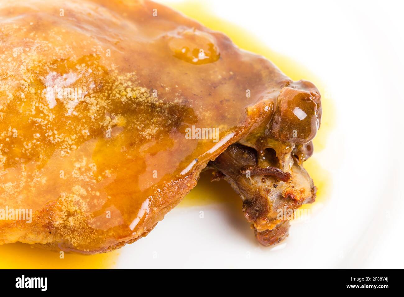 Duck leg confit with yellow sauce. Macro. Photo can be used as a whole ...