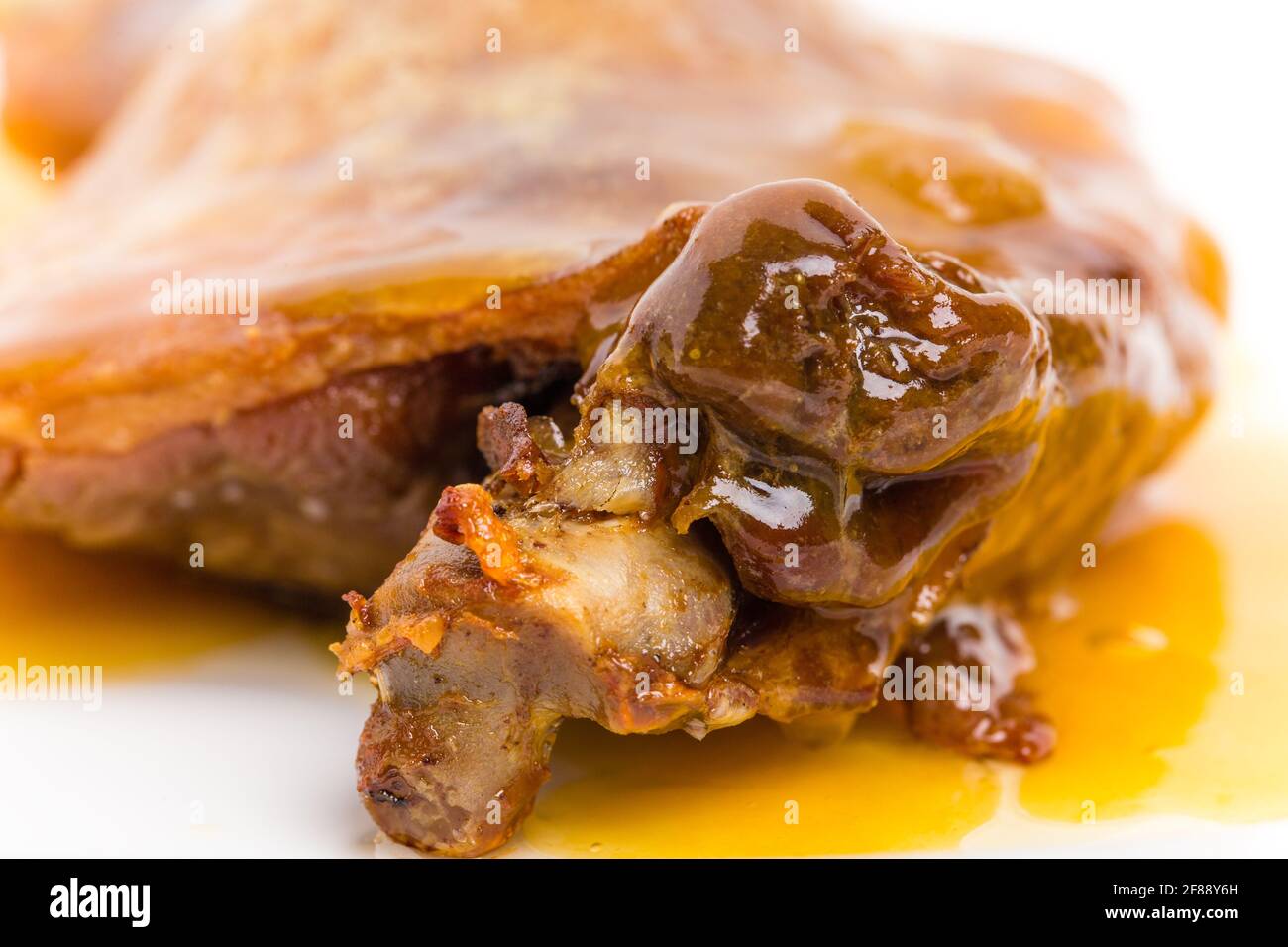 Duck leg confit with yellow sauce. Macro. Photo can be used as a whole ...