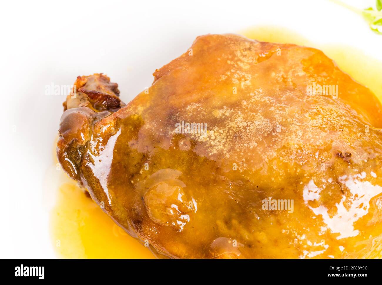 Duck leg confit with yellow sauce. Macro. Photo can be used as a whole ...