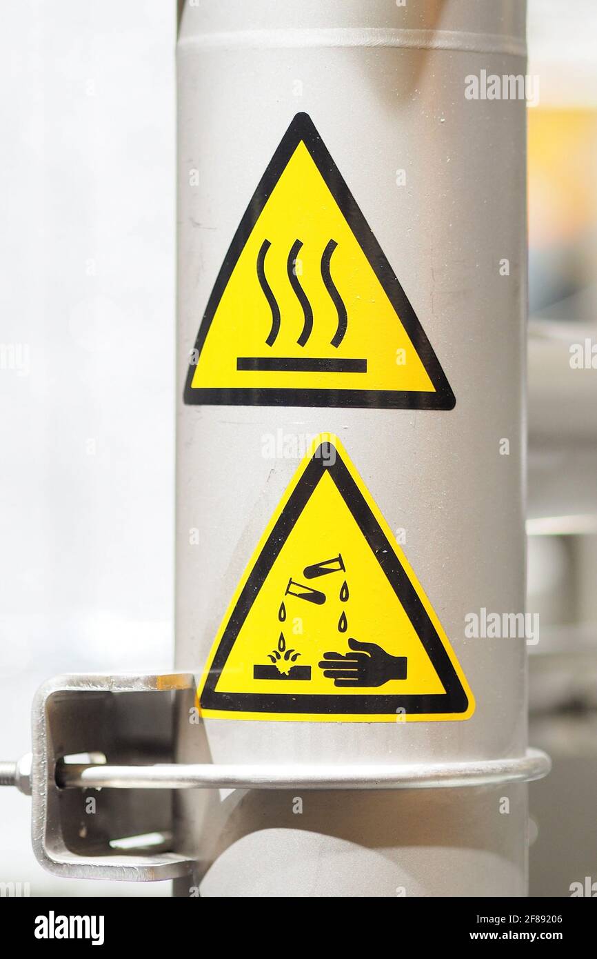 Stainless steel flange of a chemical vessel assembly with warnings for ...