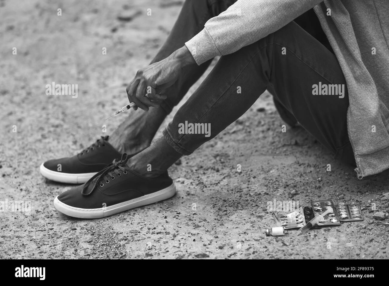 Male junkie with syringe and drugs outdoors Stock Photo - Alamy