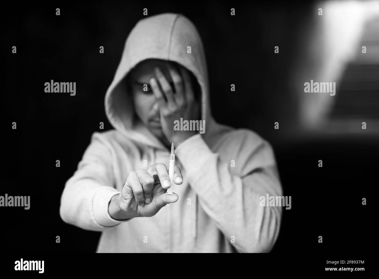 Male junkie with syringe outdoors Stock Photo - Alamy