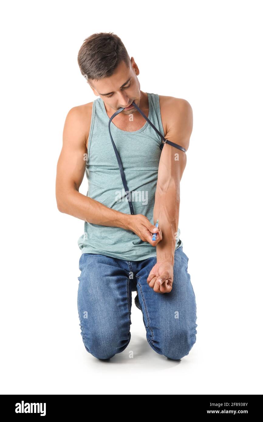 Male junkie making injection on white background Stock Photo - Alamy