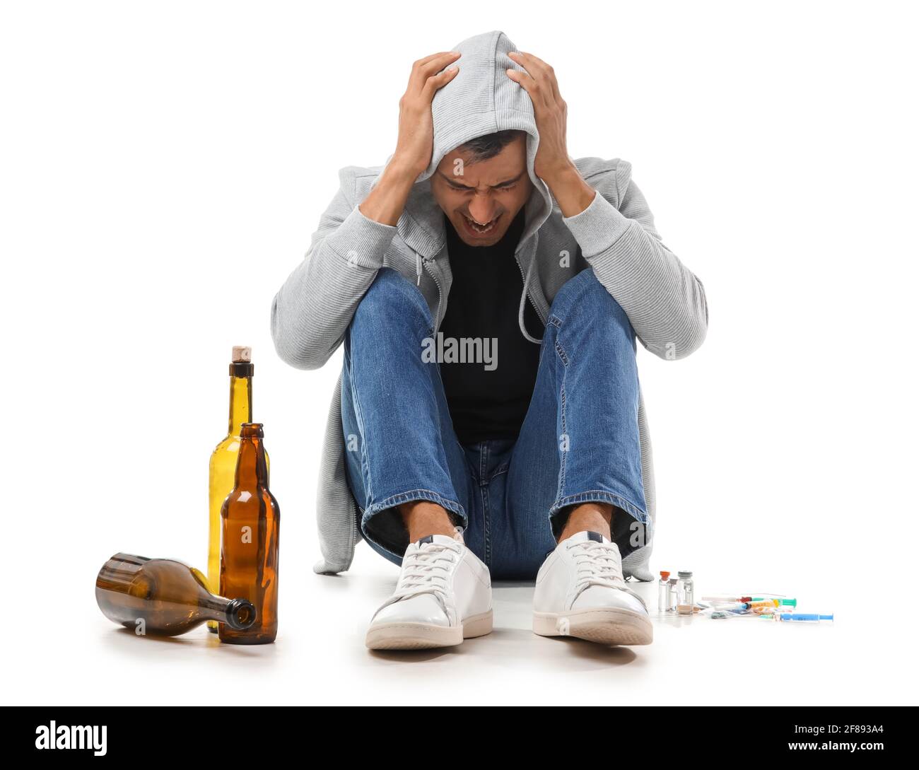 Male junkie with drugs and alcohol on white background Stock Photo - Alamy