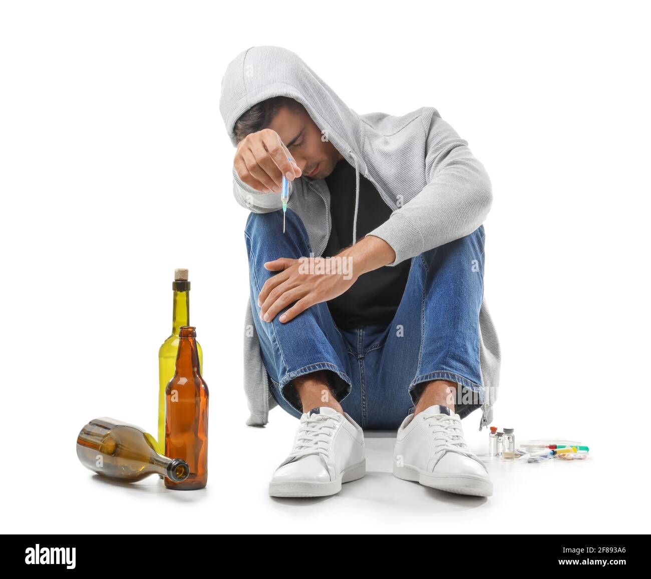Male junkie with drugs and alcohol on white background Stock Photo - Alamy