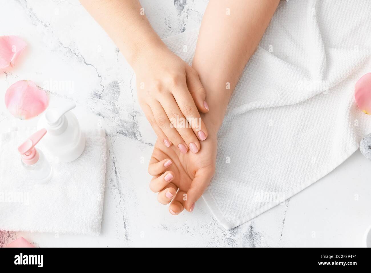 Beautiful female hands on light background Stock Photo - Alamy