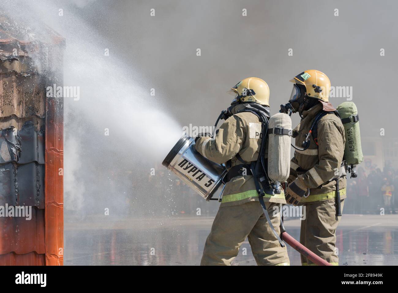 Firefighters extinguishes fire from fire hose, using firefighting water ...