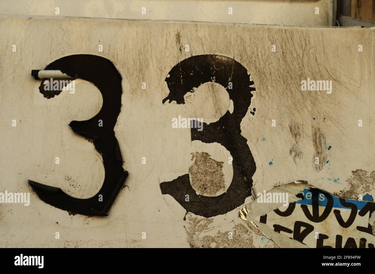 number 33 black numbers on a white background. tattered and worn and ...